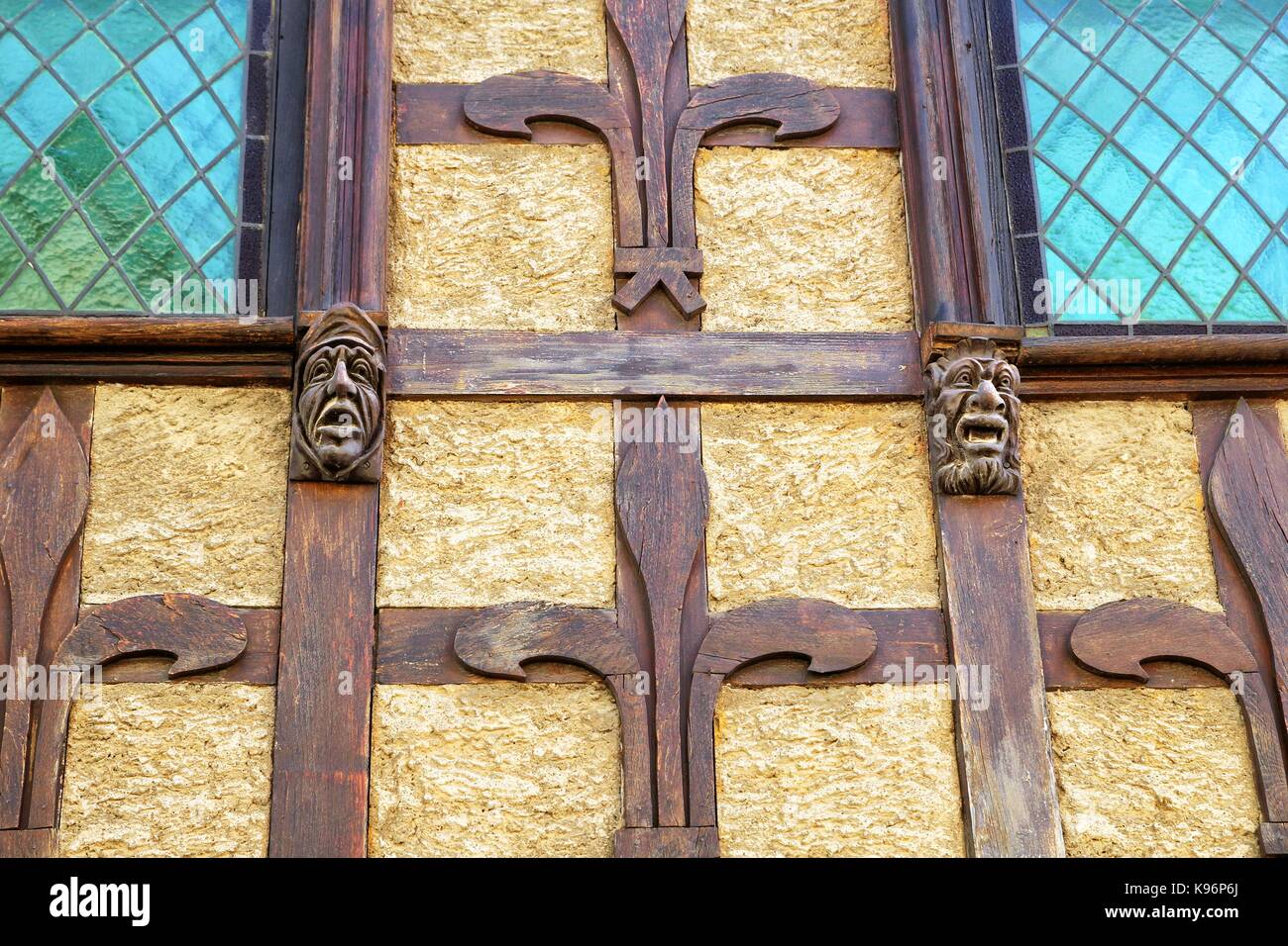 Unusual carved gothic head features on a tudor style wood framed ...
