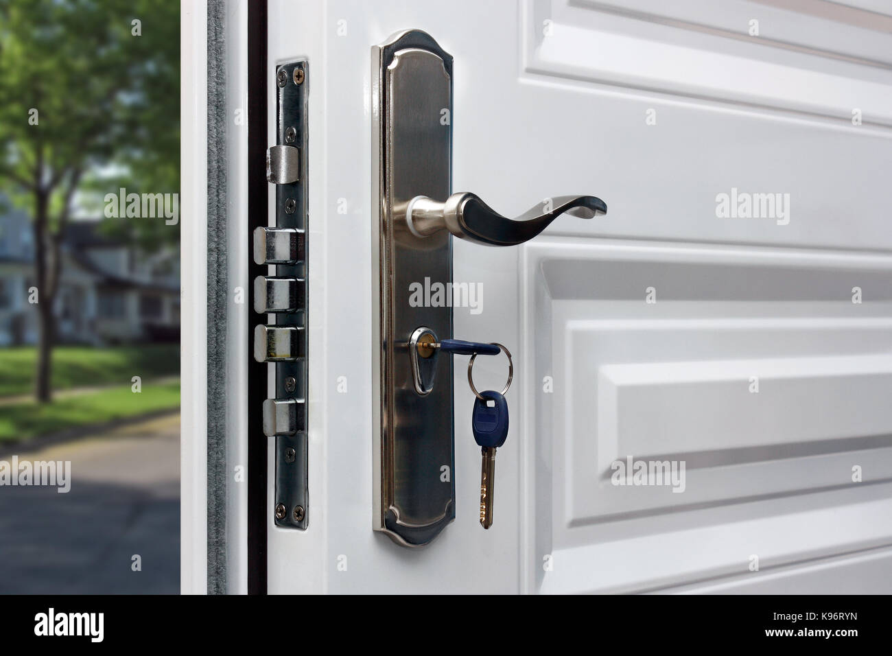 Open door of a family home. Close-up of the lock with your keys on an ...