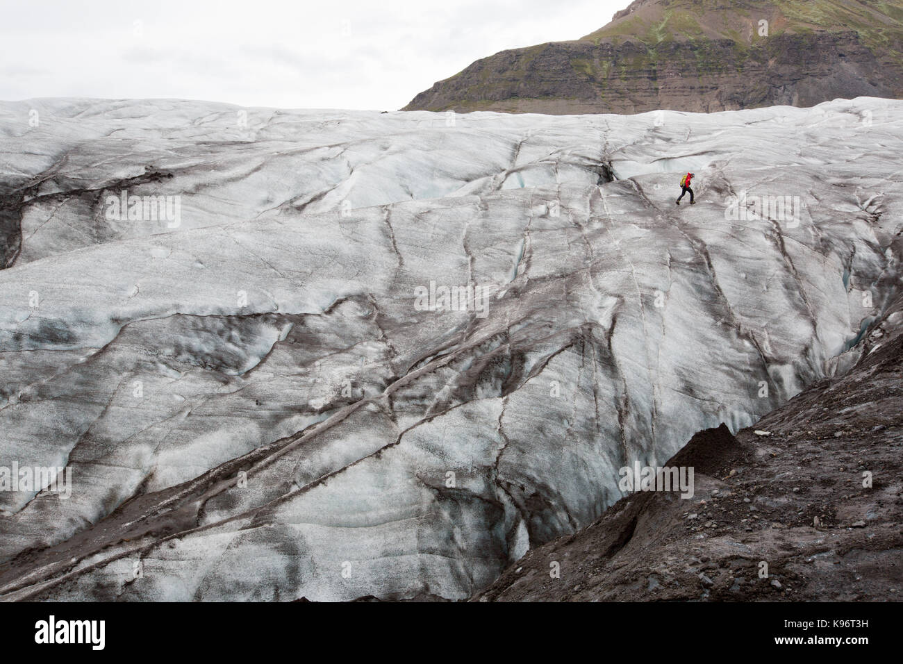 A hiker walks across the ice on Skaftafell Glacier Stock Photo - Alamy