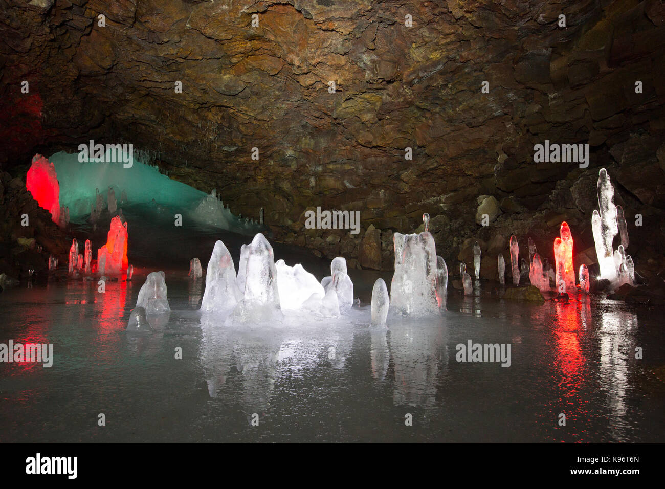 In a cave, stalagmites made of ice are illuminated by light Stock Photo ...