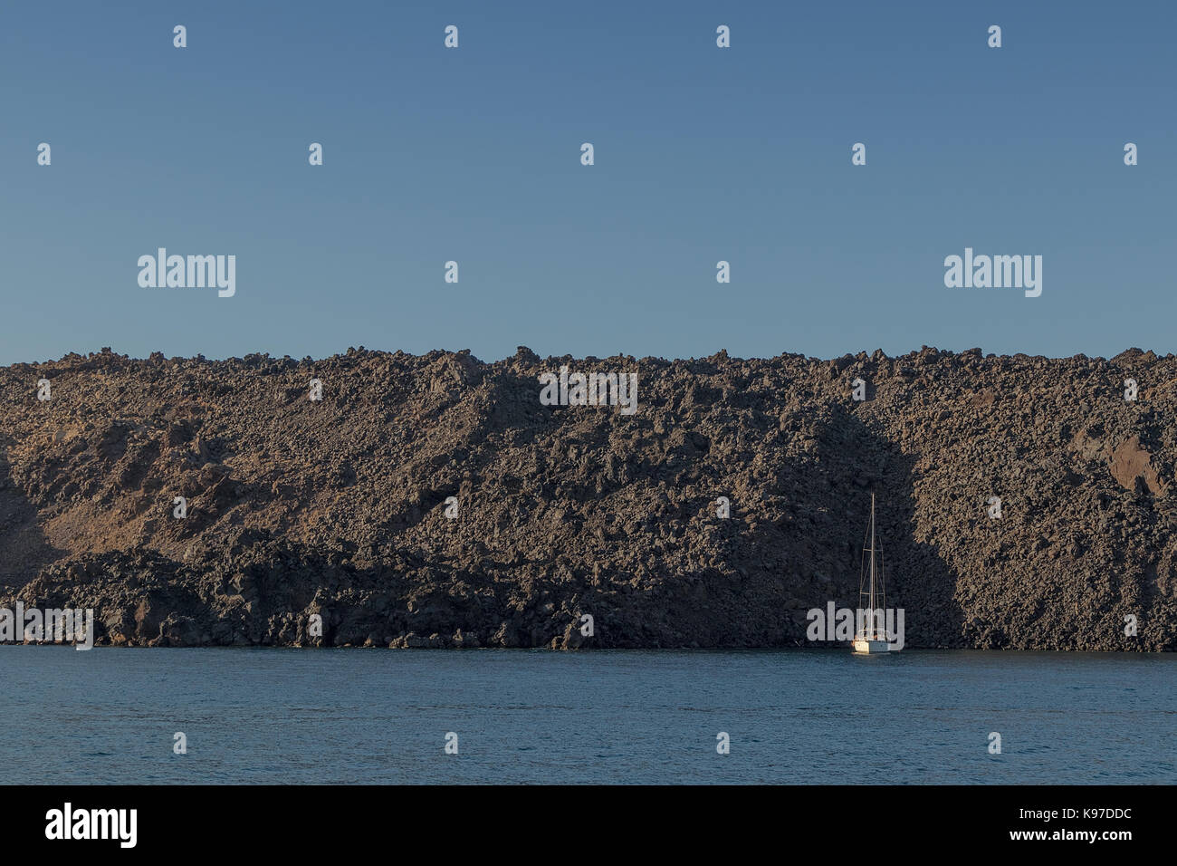 sailboat with cliff behind in the sea of santorini Stock Photo - Alamy