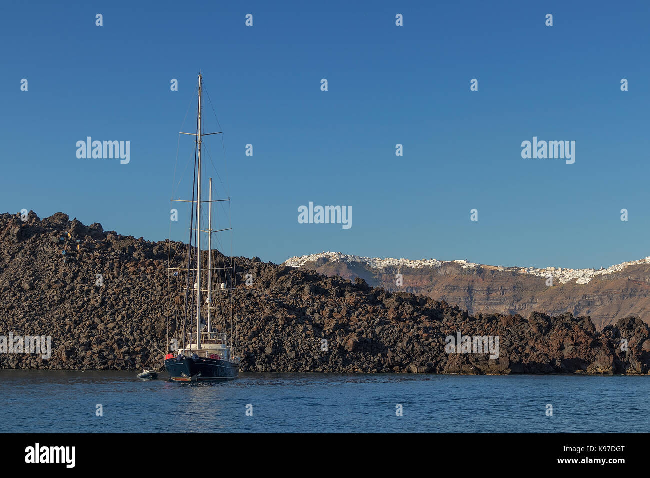 sailboat with cliff behind in the sea of santorini Stock Photo - Alamy