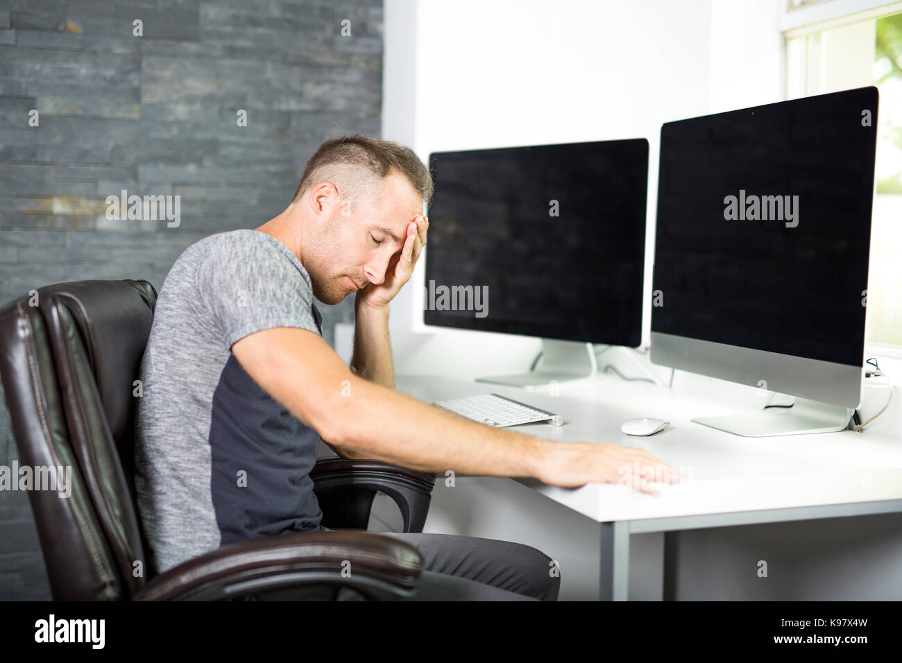 Young business man with problems and stress in the office Stock Photo ...