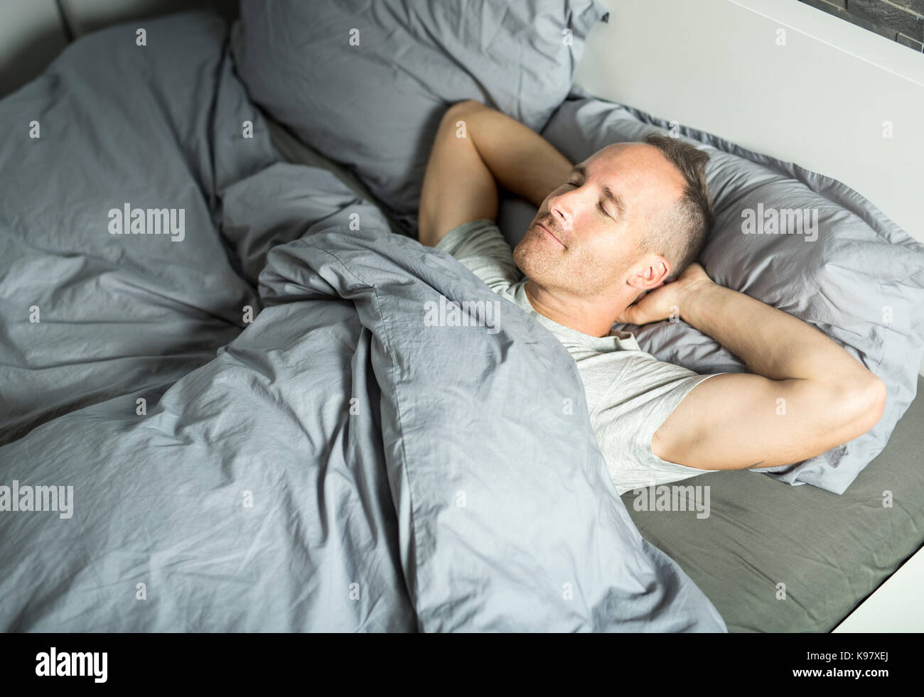 Portrait of a young man from above sleeping in bed Stock Photo - Alamy