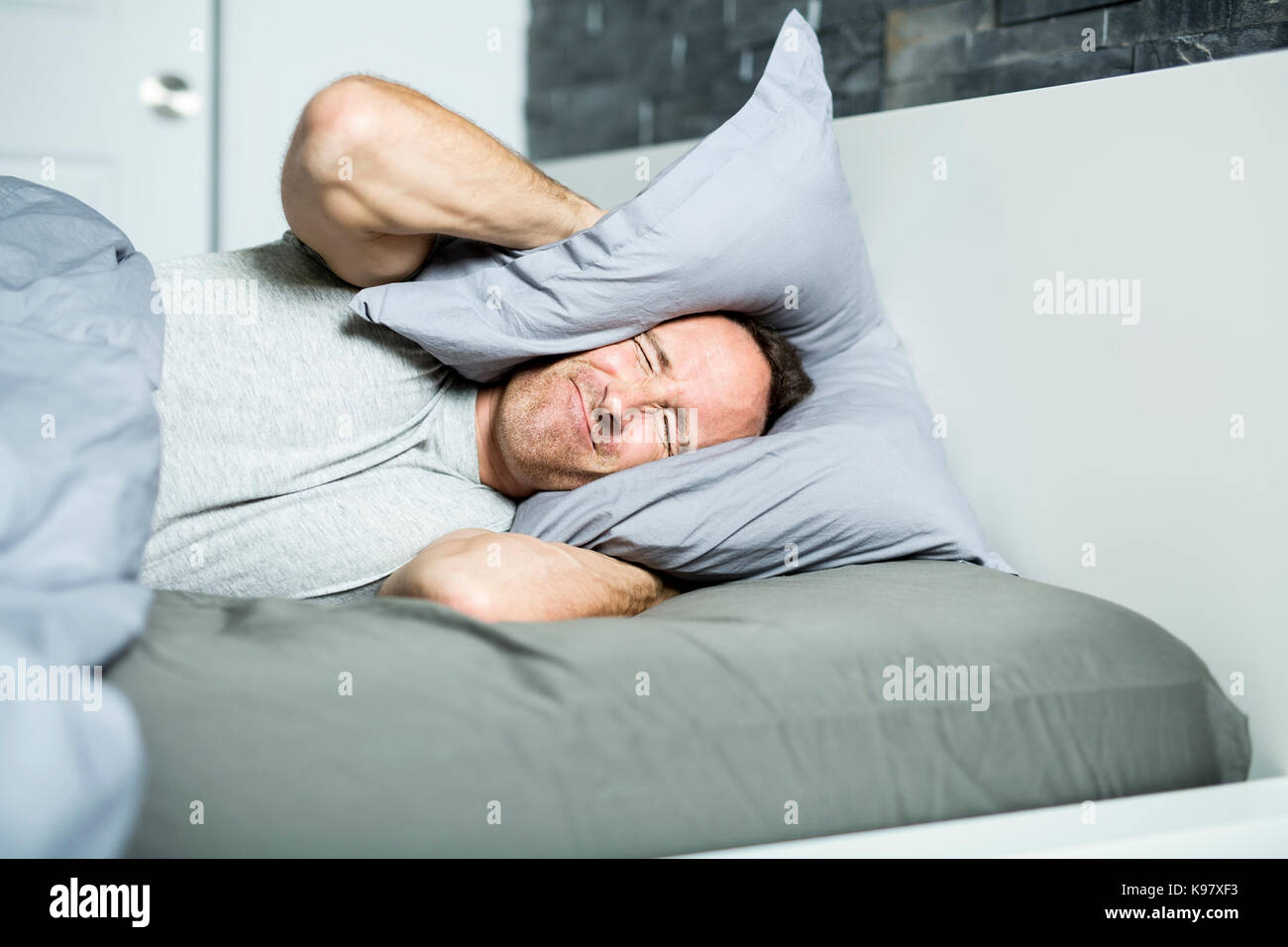 Tired man in the bed Stock Photo - Alamy