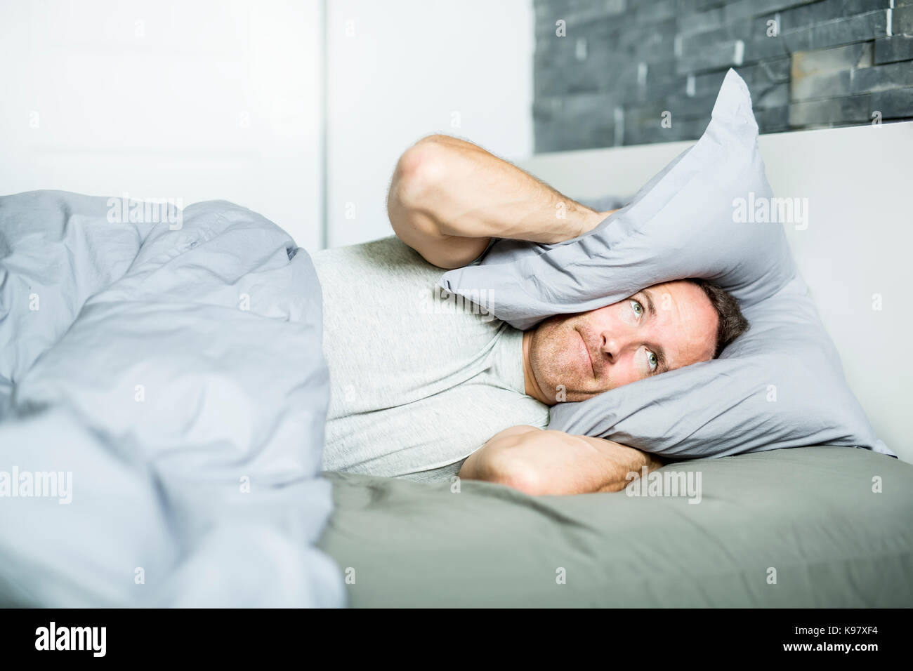 Tired man in the bed Stock Photo - Alamy