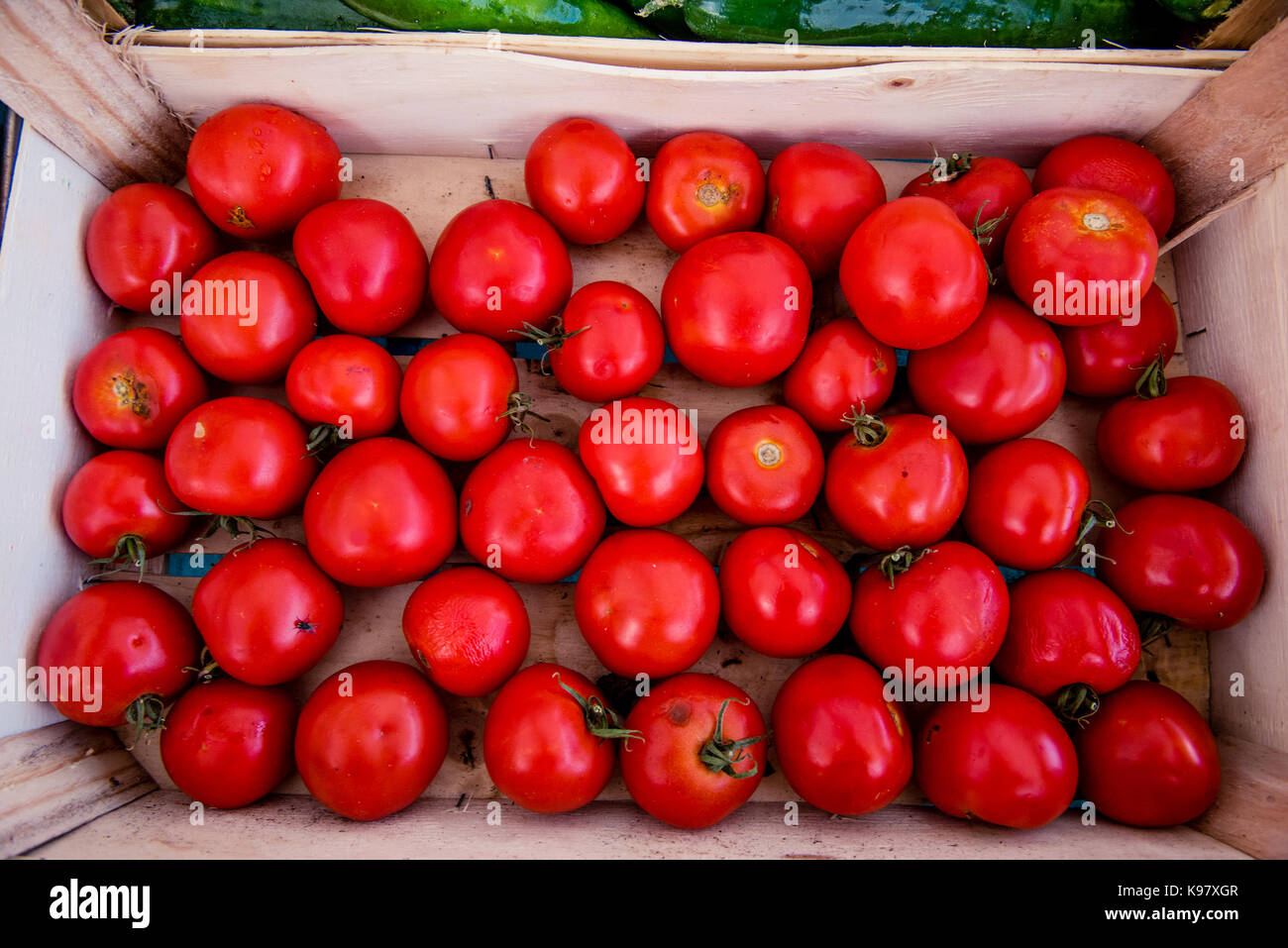 Market stall wood case full of manitoba tomatoes close up high angle ...
