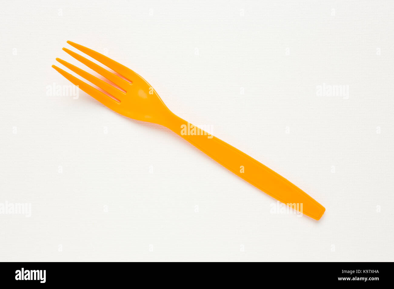 Close up of orange fork on white canvas background Stock Photo - Alamy