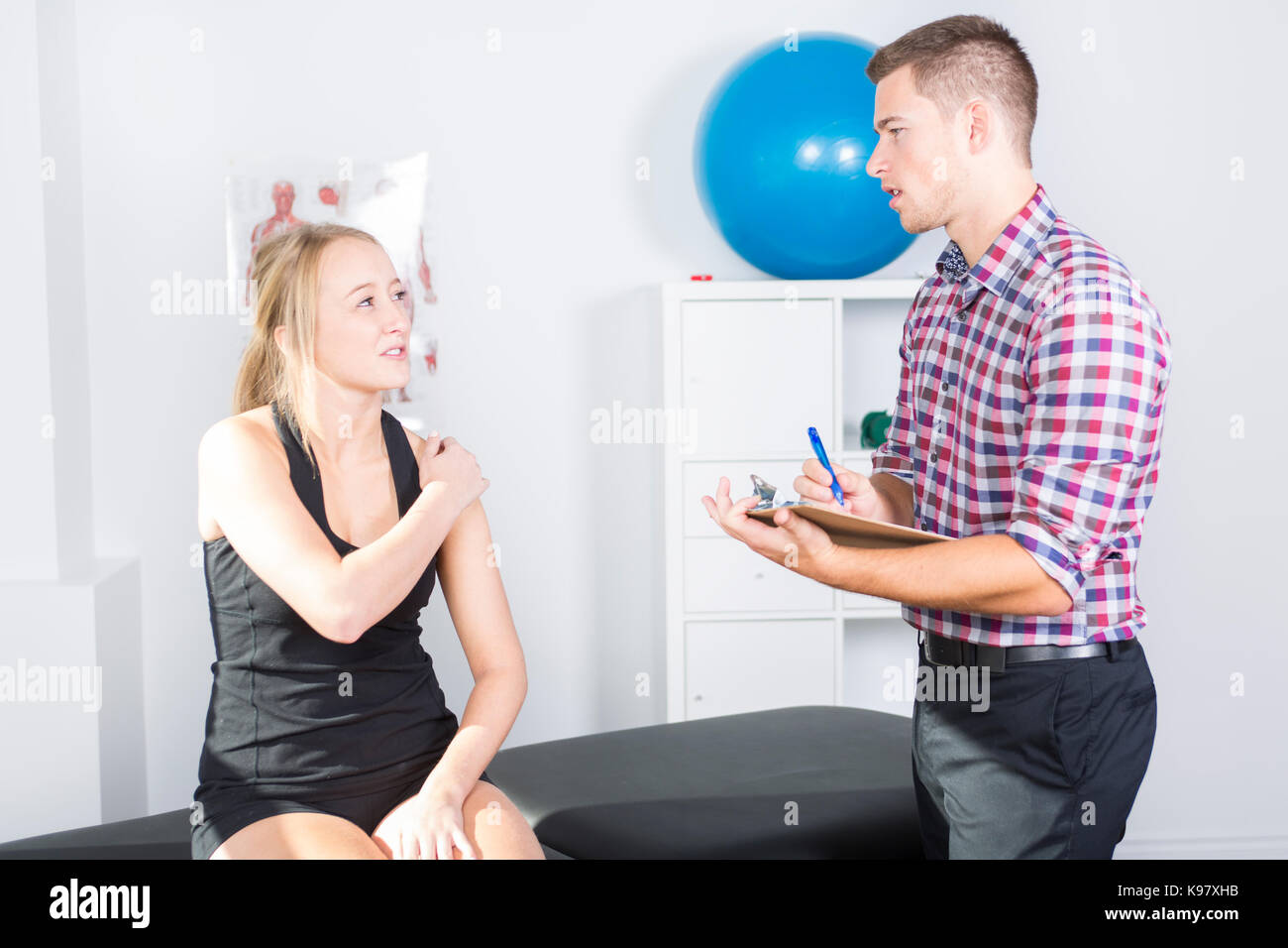 male physio therapist and woman helping patient Stock Photo - Alamy