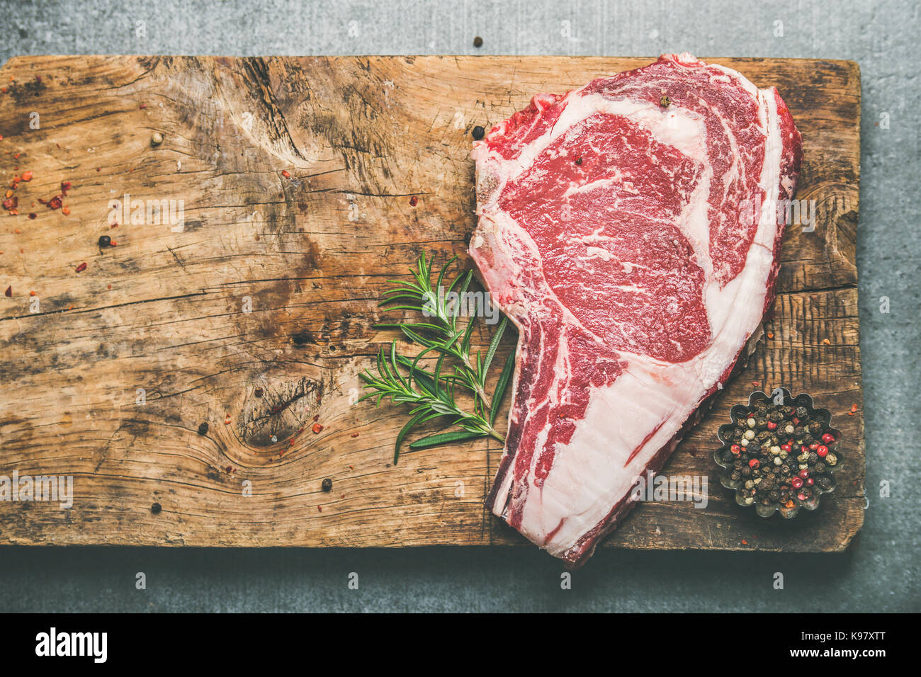 Raw uncooked beef steak rib-eye on board, copy space Stock Photo - Alamy