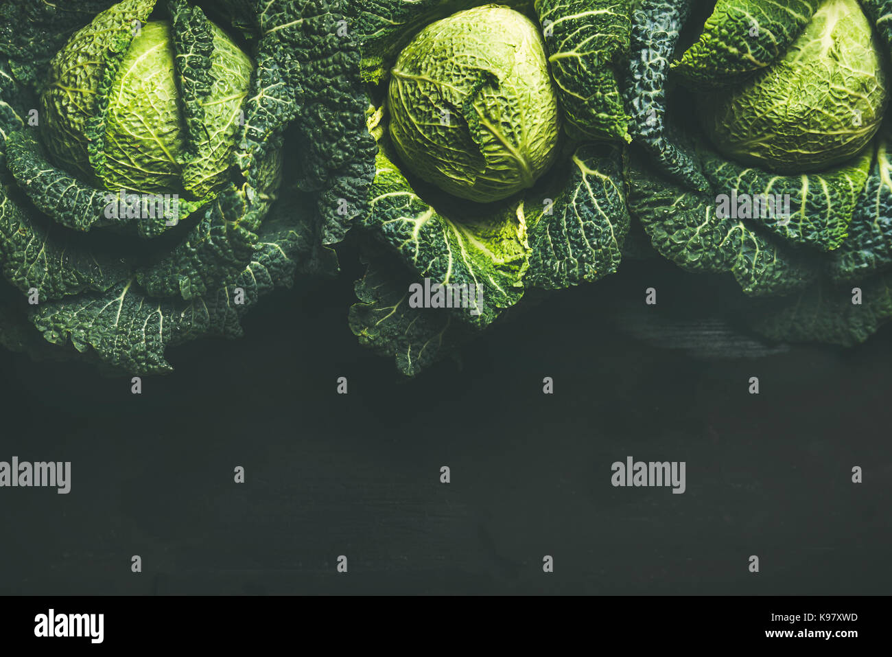 Raw fresh uncooked green cabbage over dark background, top view Stock ...