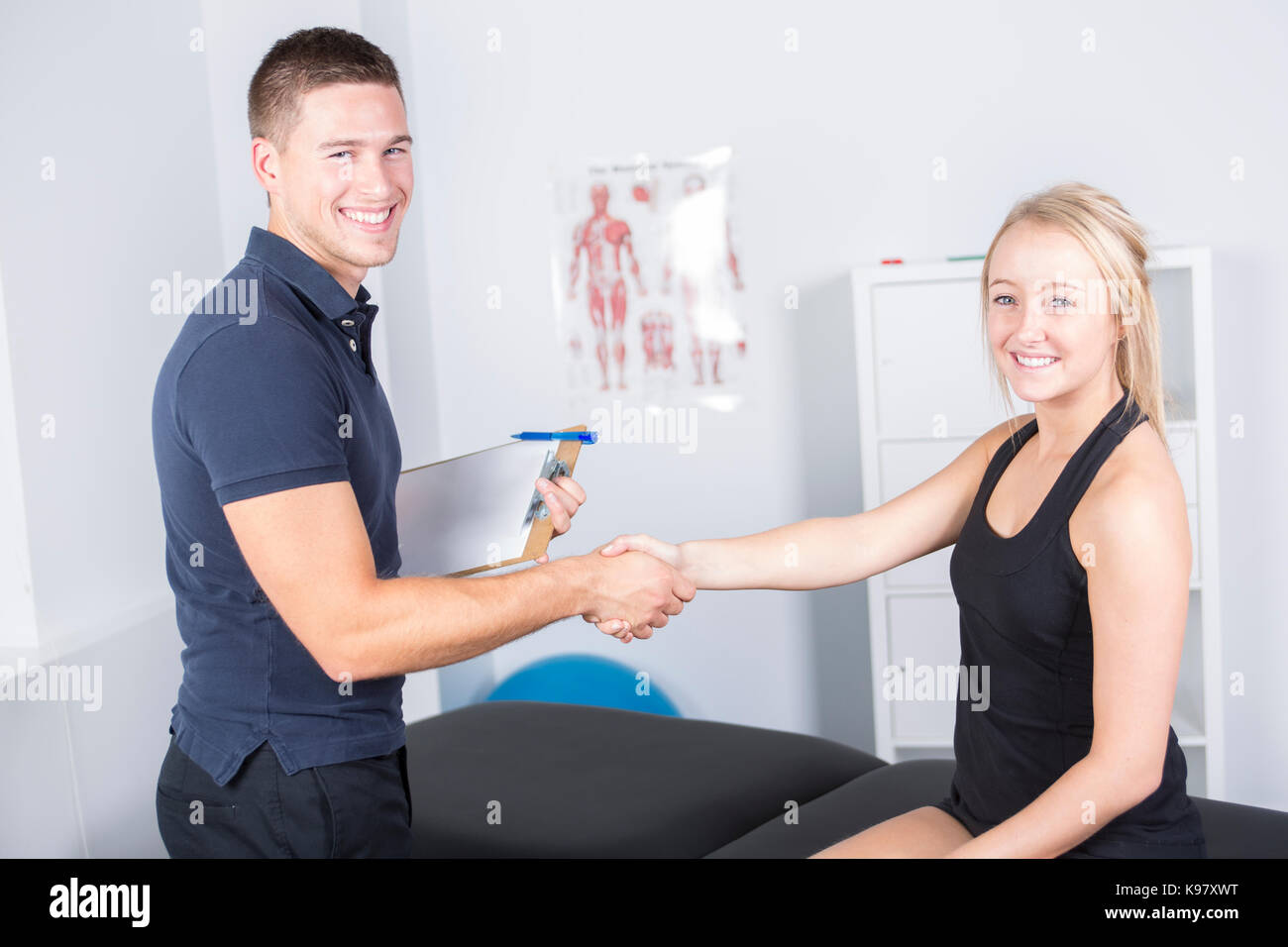 male physio therapist and woman helping patient Stock Photo - Alamy