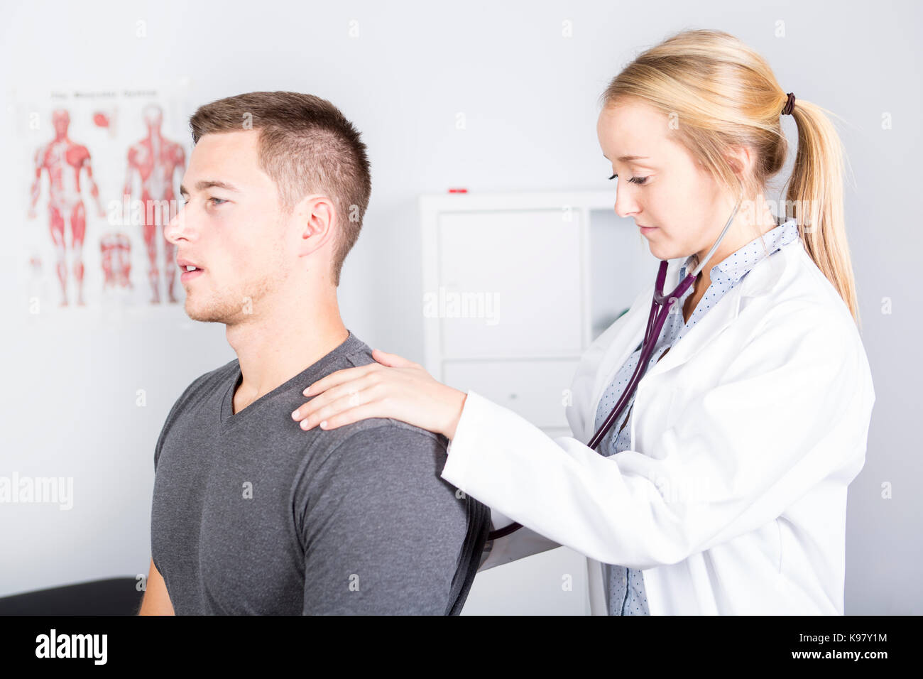 Doctor examining her patient in medical office Stock Photo - Alamy