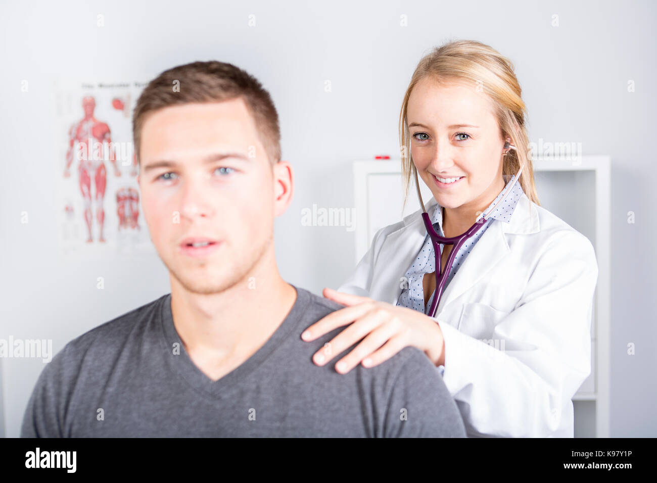 Doctor examining her patient in medical office Stock Photo - Alamy
