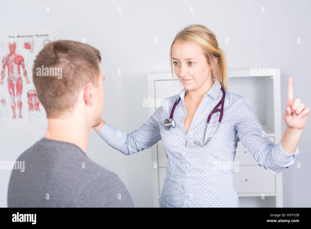 Doctor examining her patient in medical office Stock Photo - Alamy