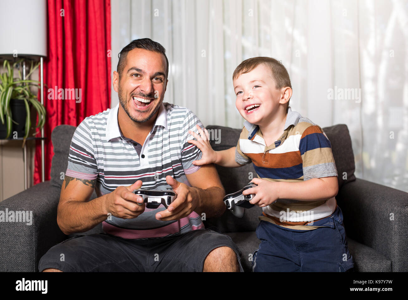 Father and son playing video game Stock Photo - Alamy