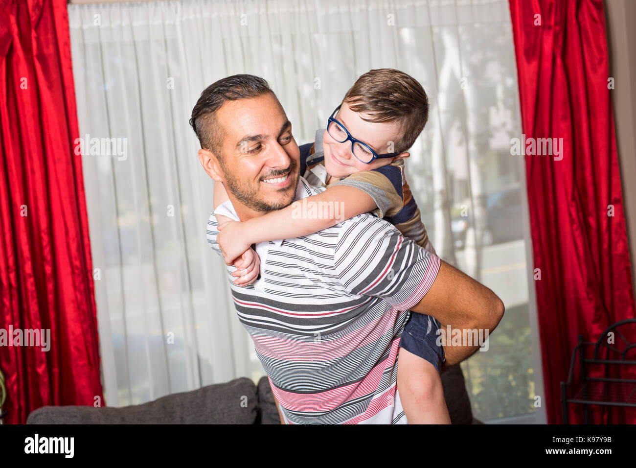 Father and son having fun at home in living room Stock Photo - Alamy