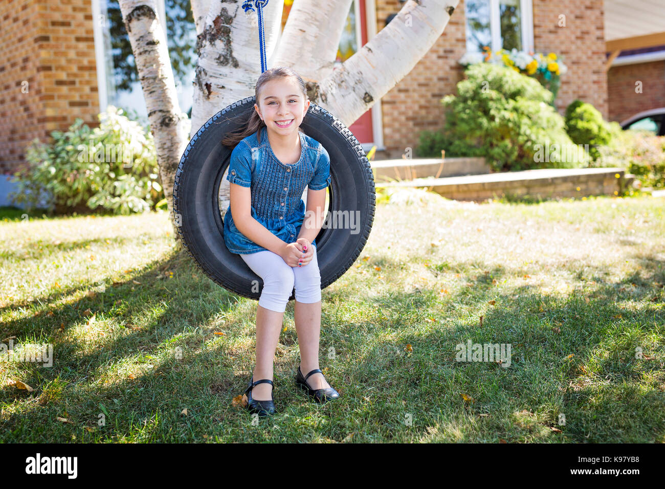 Portrait of girl on tire swing Stock Photo - Alamy
