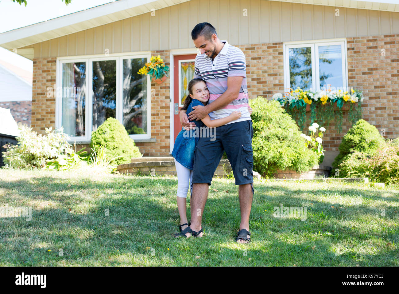 Portrait of happy family in front house Stock Photo - Alamy