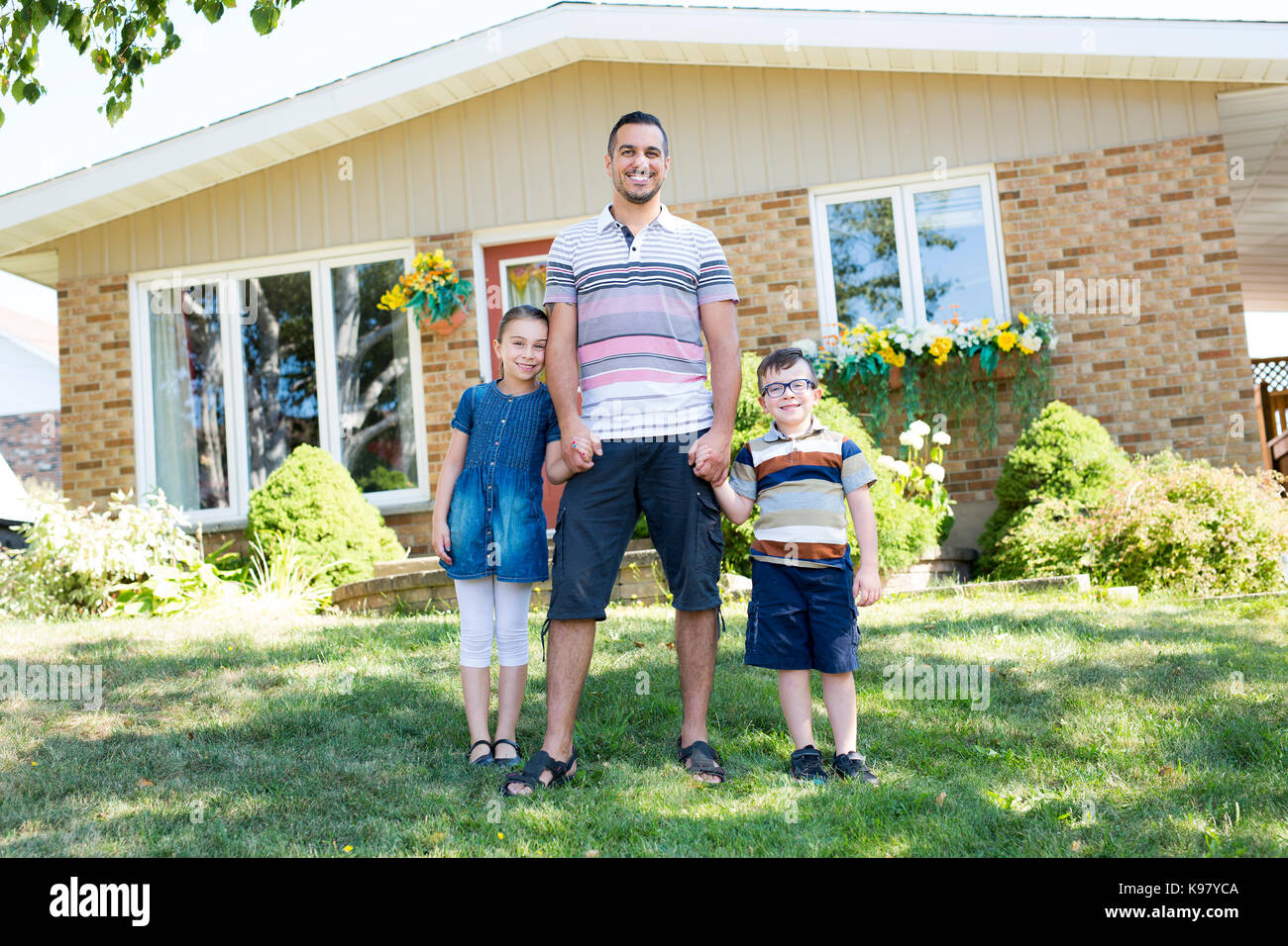 Portrait of happy family in front house Stock Photo - Alamy