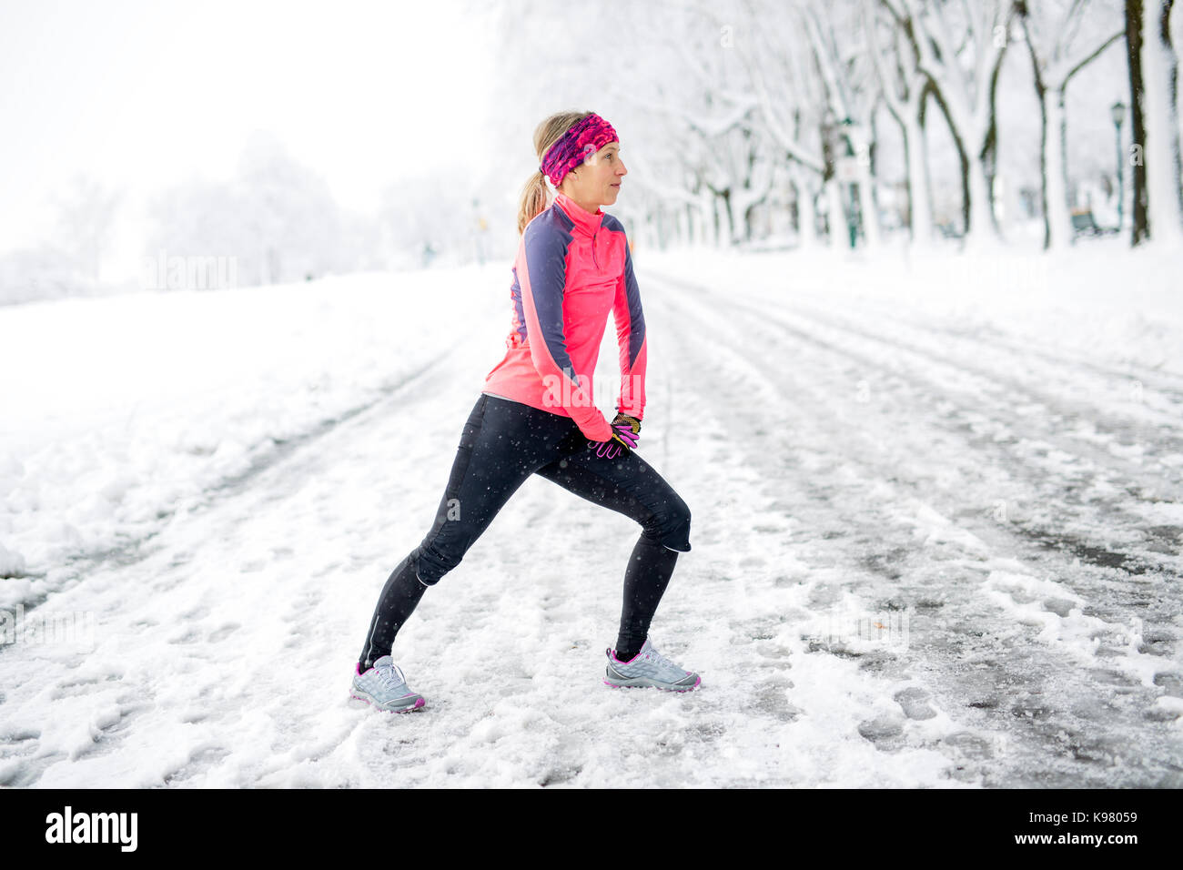 A Fitness running woman in winter season Stock Photo - Alamy