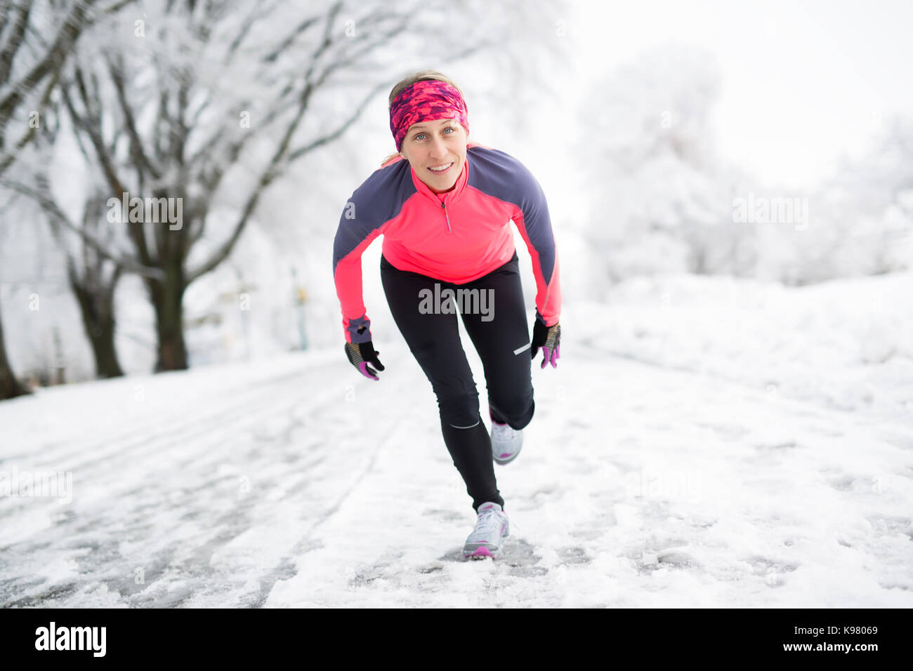 A Fitness running woman in winter season Stock Photo - Alamy