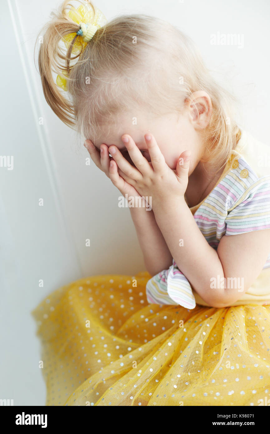 Weeping young blond girl indoor Stock Photo - Alamy
