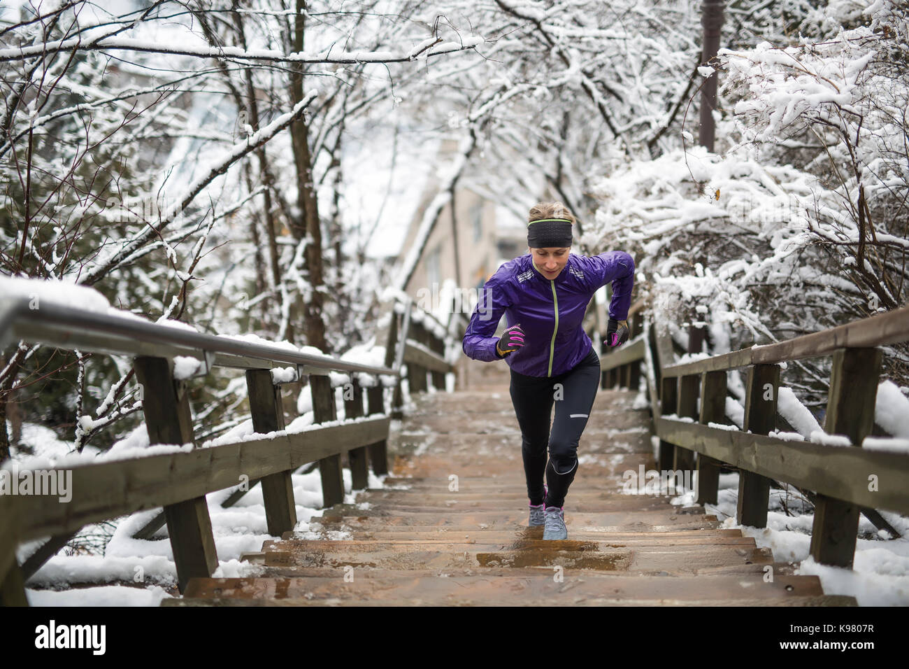 A Fitness running woman in winter season Stock Photo - Alamy