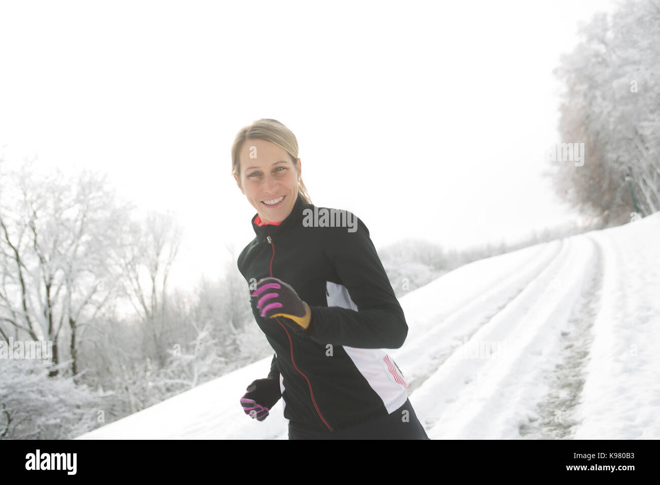 A Fitness running woman in winter season Stock Photo - Alamy