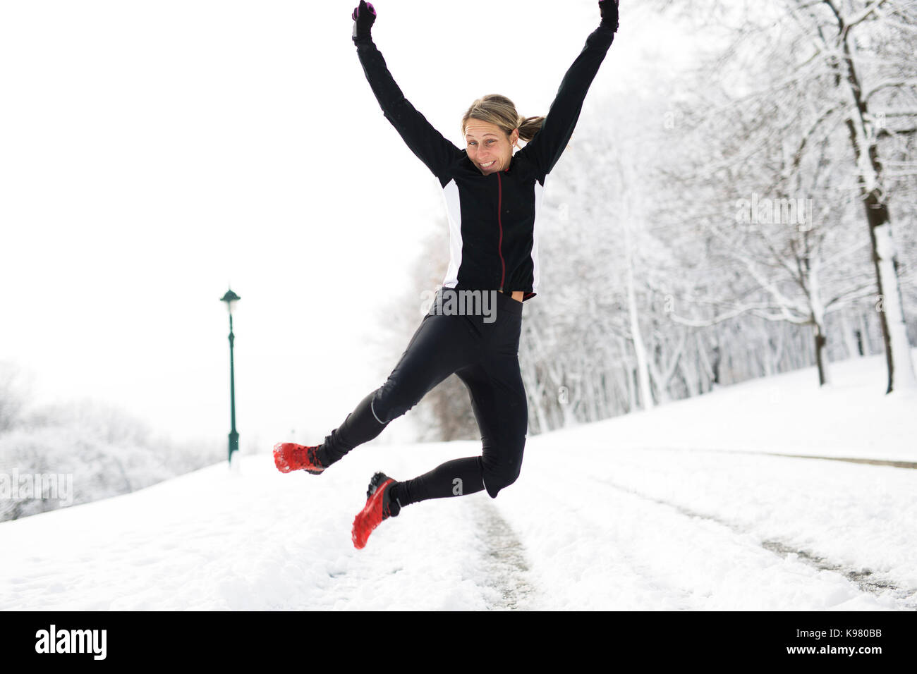 A Fitness running woman in winter season Stock Photo - Alamy