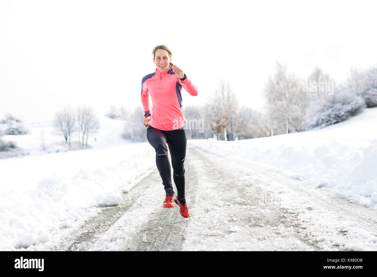 A Fitness running woman in winter season Stock Photo - Alamy