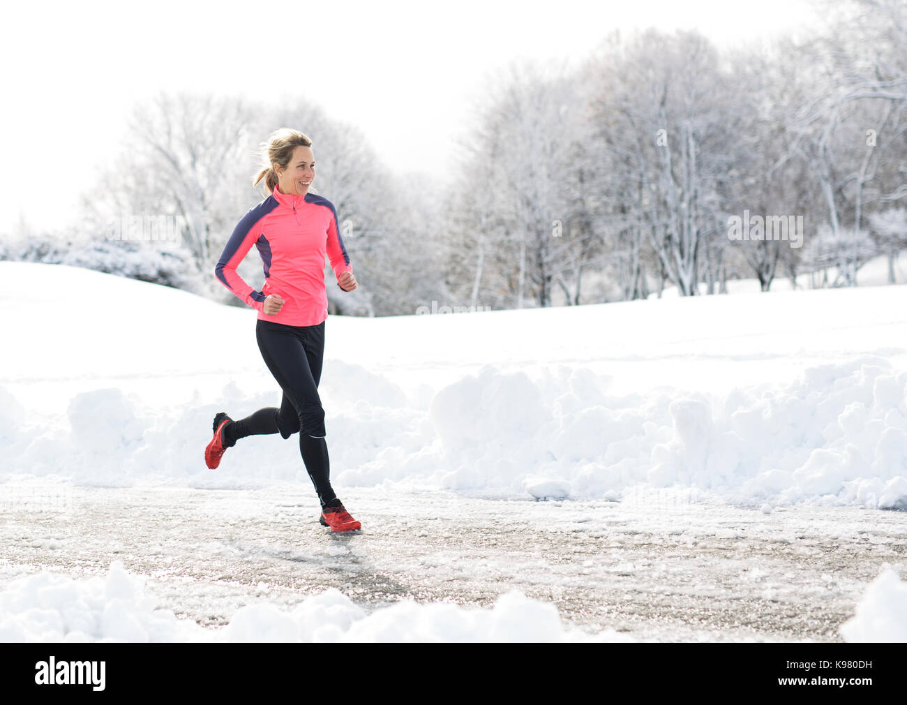 A Fitness running woman in winter season Stock Photo - Alamy
