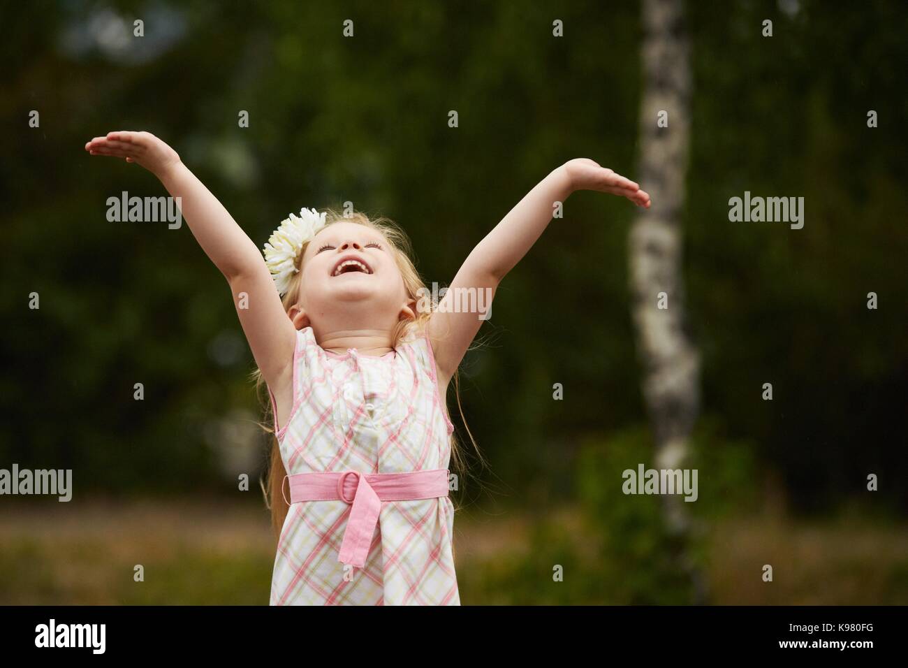 Young girl hands up. Happy. Outdoors Stock Photo - Alamy