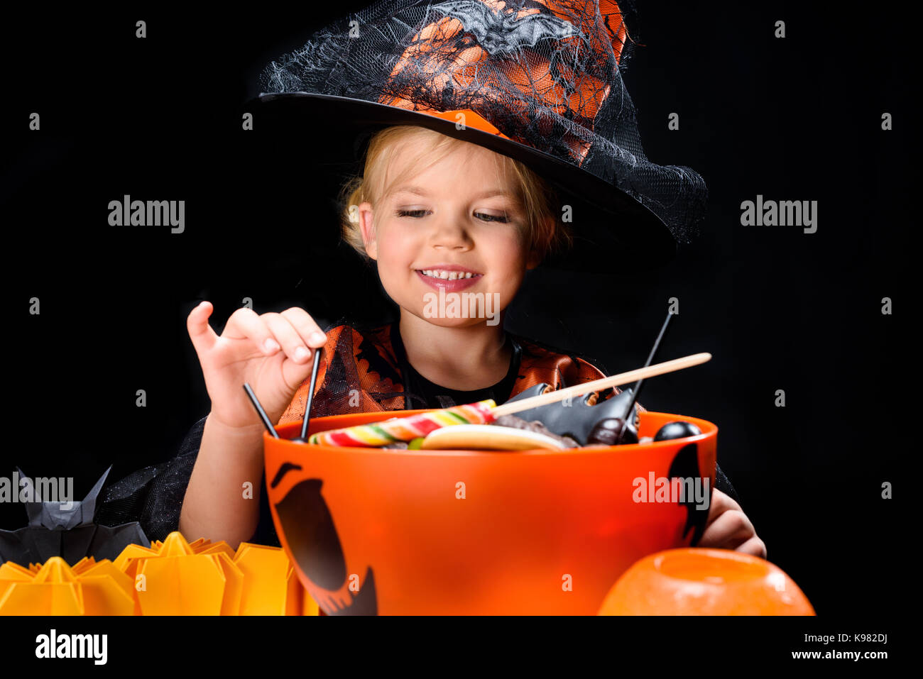 little witch with halloween sweets Stock Photo - Alamy