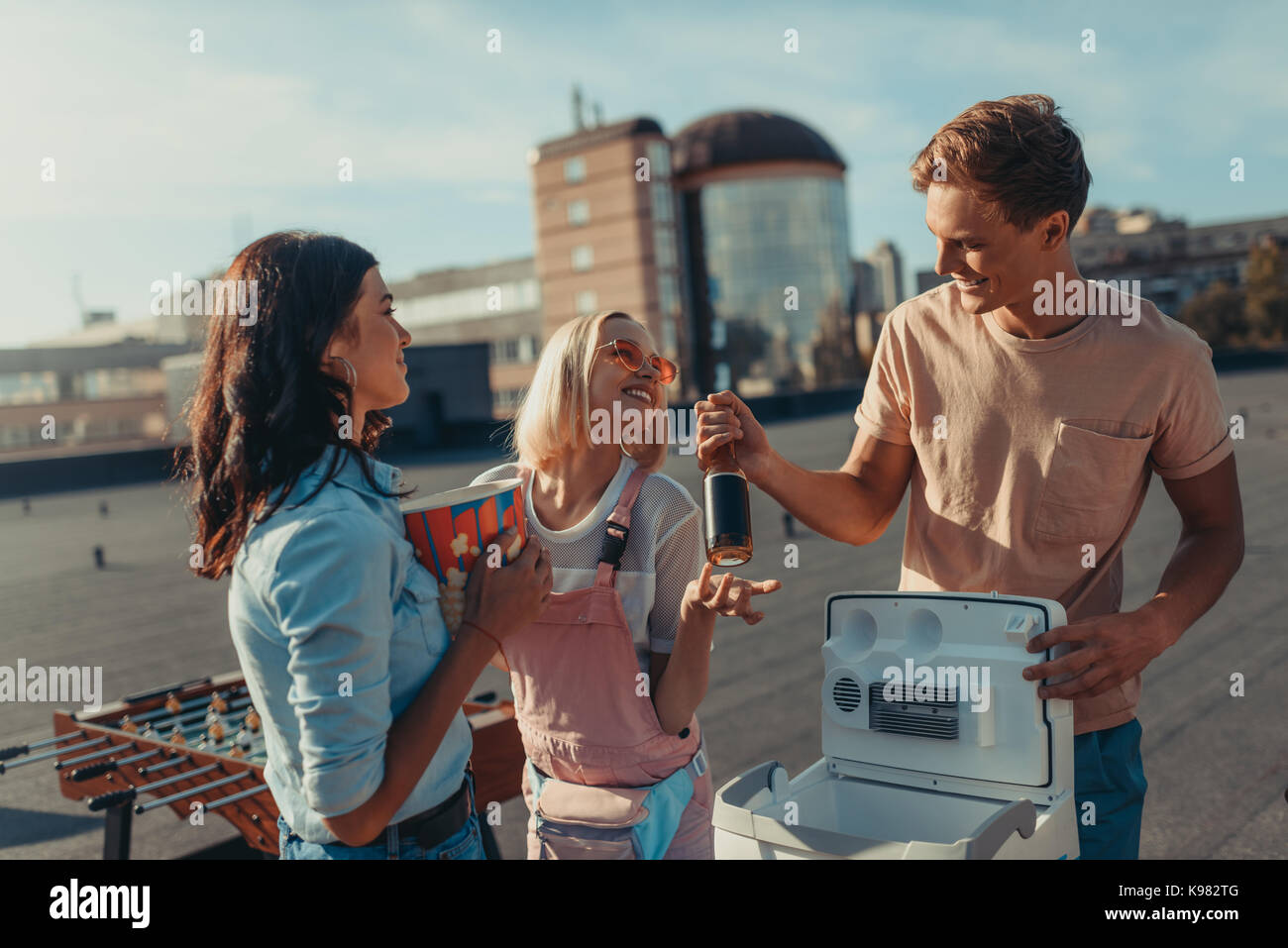 group of friends sharing beer Stock Photo - Alamy