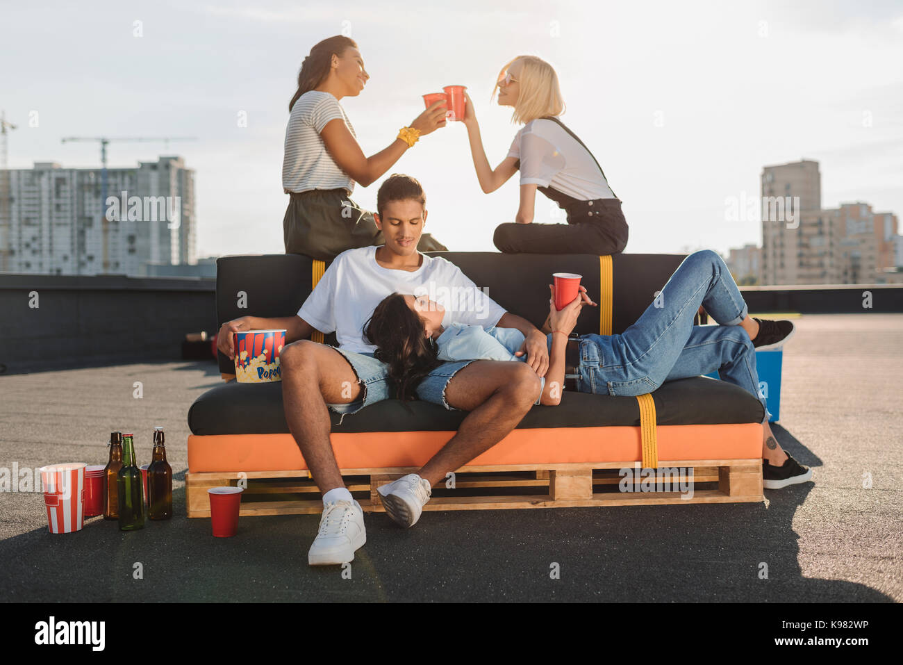 friends relaxing on roof Stock Photo - Alamy