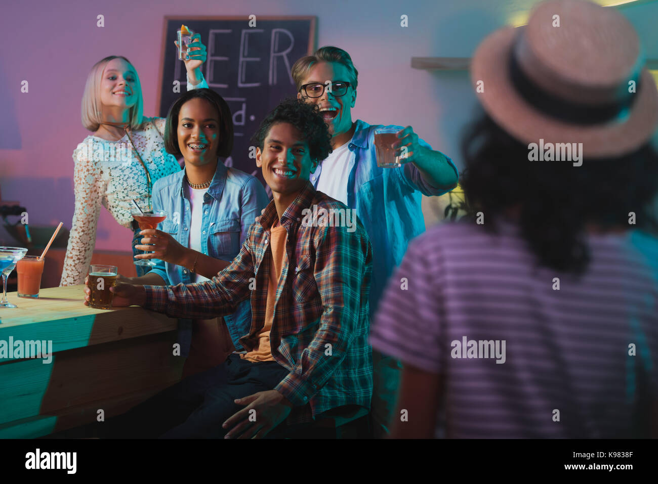 multicultural people greeting friend at party Stock Photo - Alamy