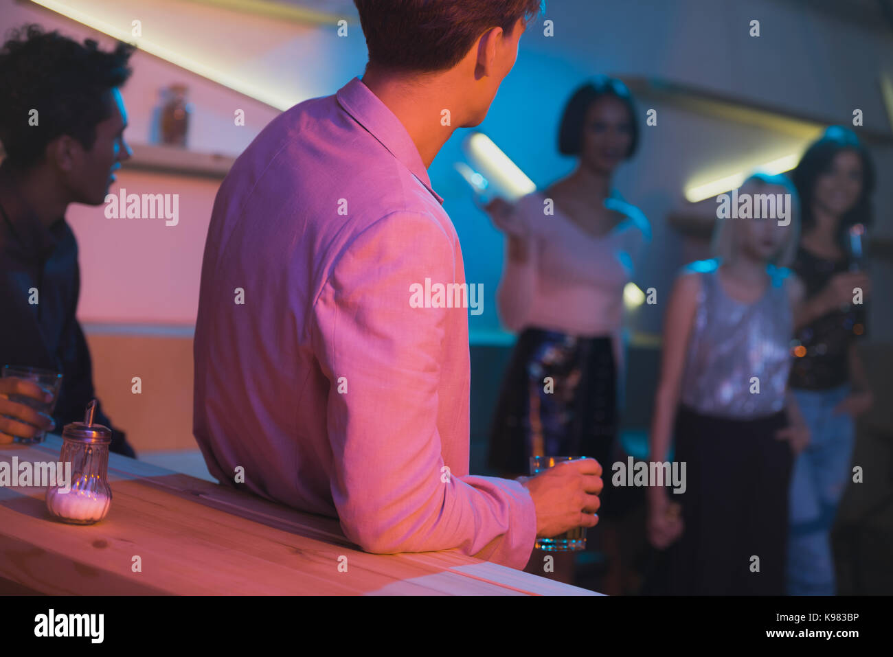 man leaning on wooden counter Stock Photo - Alamy