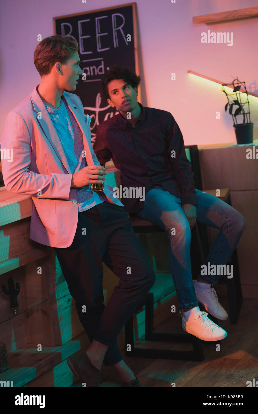 multiethnic men having conversation in bar Stock Photo - Alamy