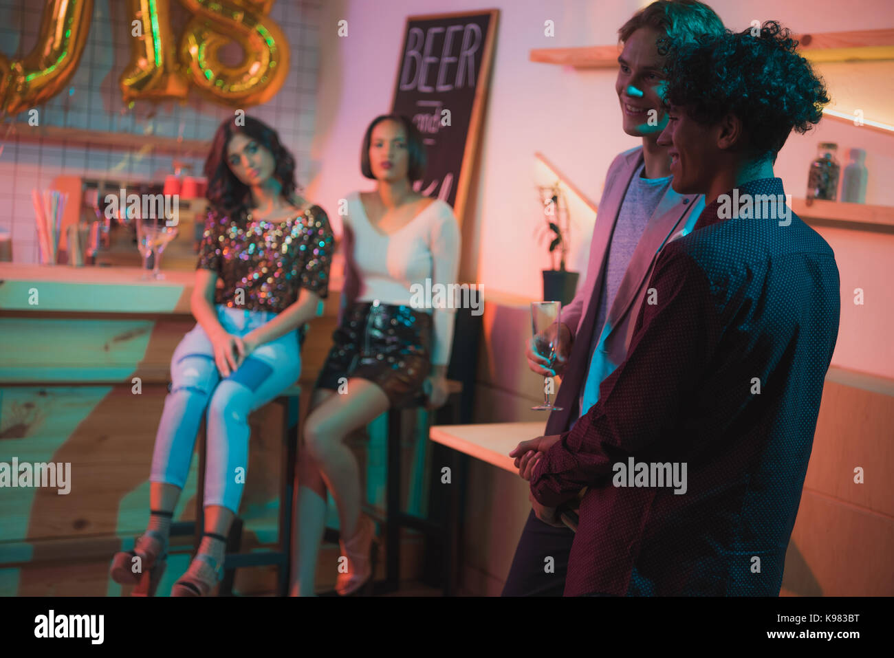 multiethnic men having conversation in bar Stock Photo - Alamy