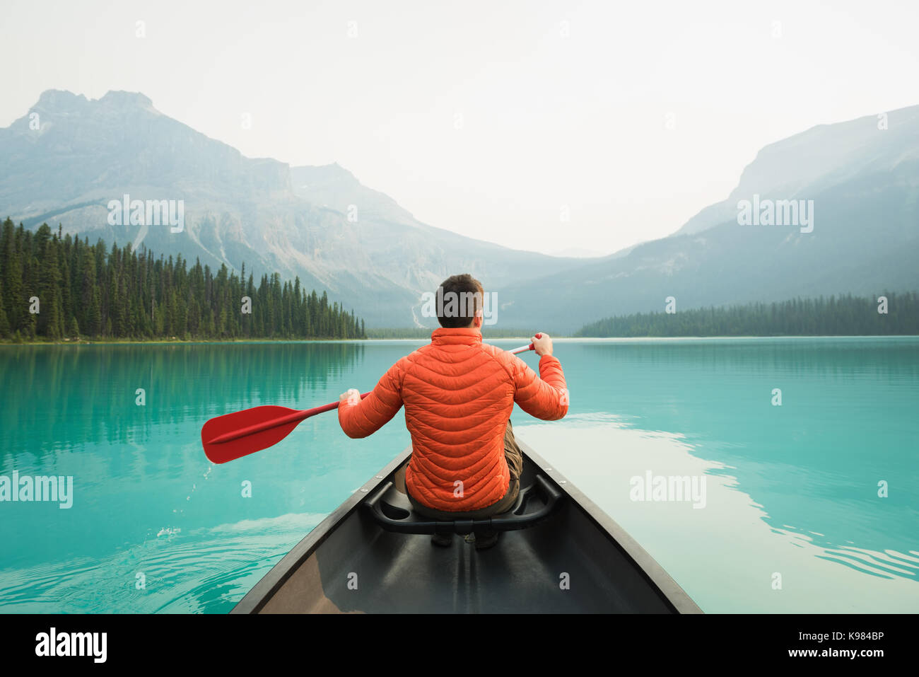 Rear view of man kayaking in lake Stock Photo - Alamy