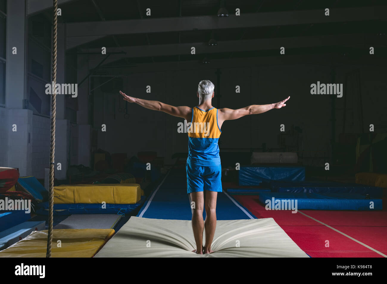 Rear view of male gymnast ready to perform gymnastic exercise in the ...