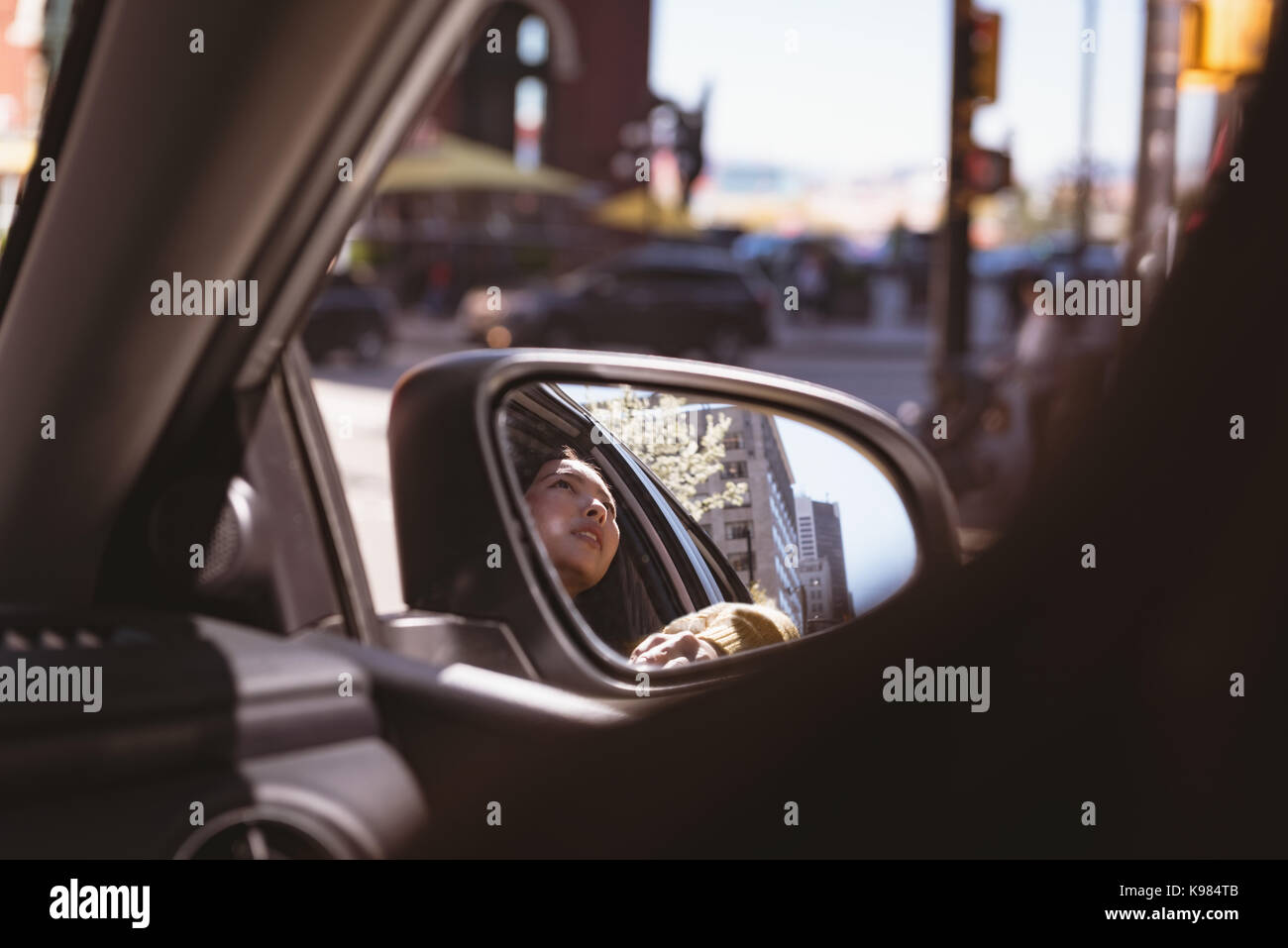 Close-up of reflection of woman in wing mirror Stock Photo - Alamy