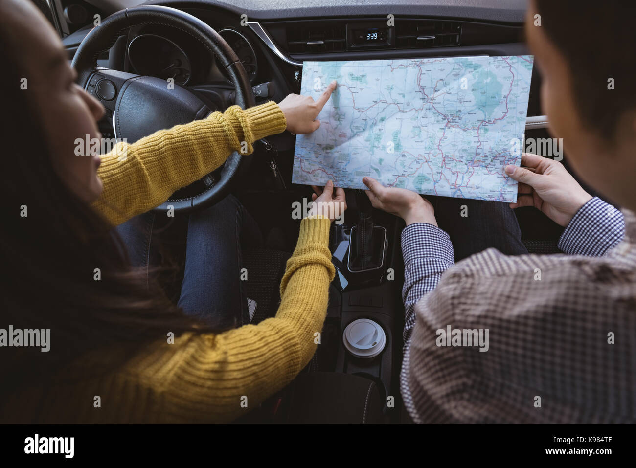 Couple looking at map in car Stock Photo - Alamy