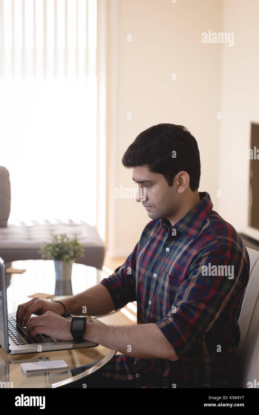 Indian man using laptop home hi-res stock photography and images - Alamy