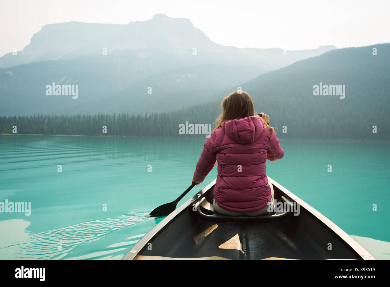 Rear view of woman kayaking in lake Stock Photo - Alamy