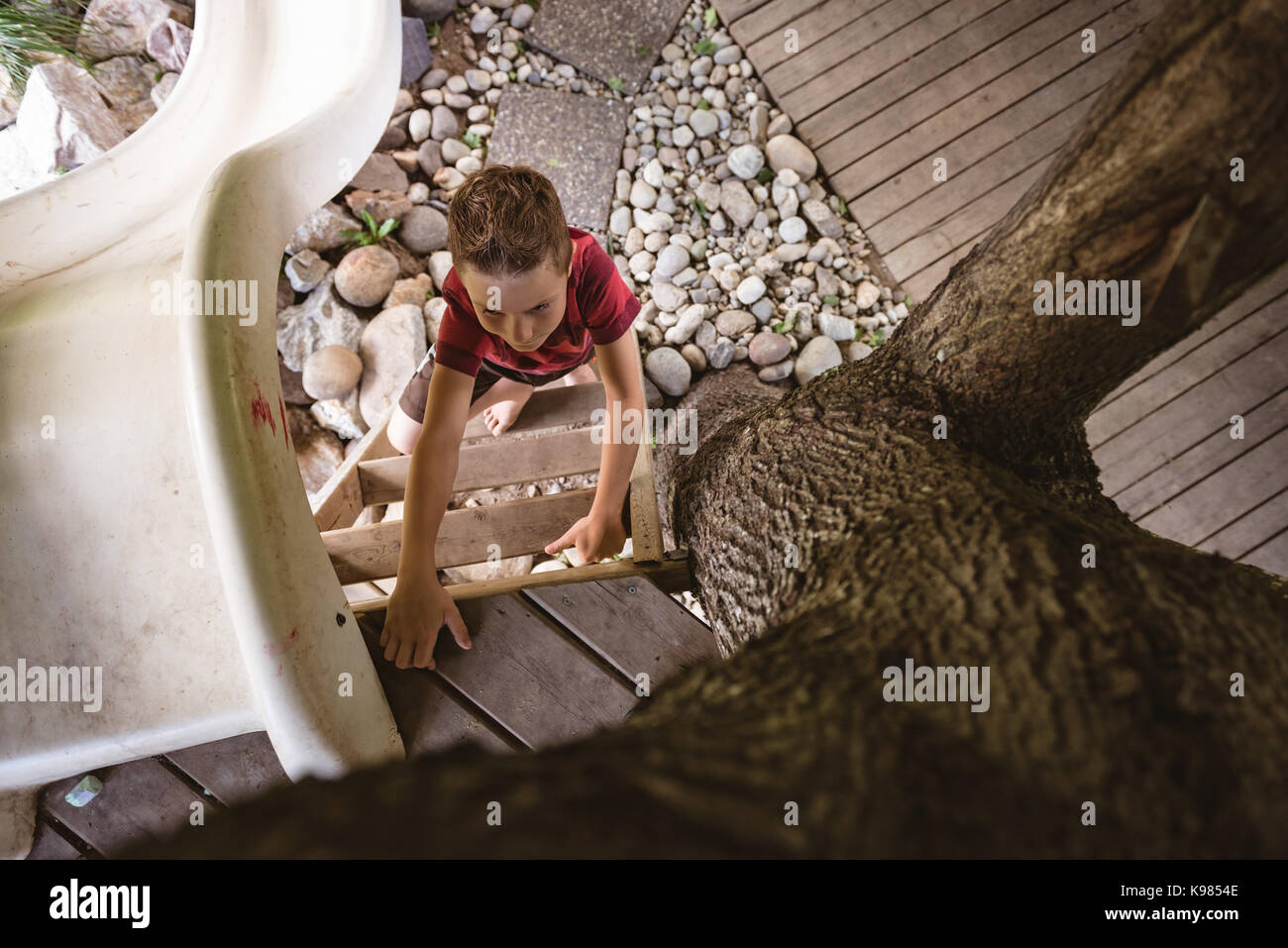 Overhead of boy climbing ladder in playground Stock Photo - Alamy
