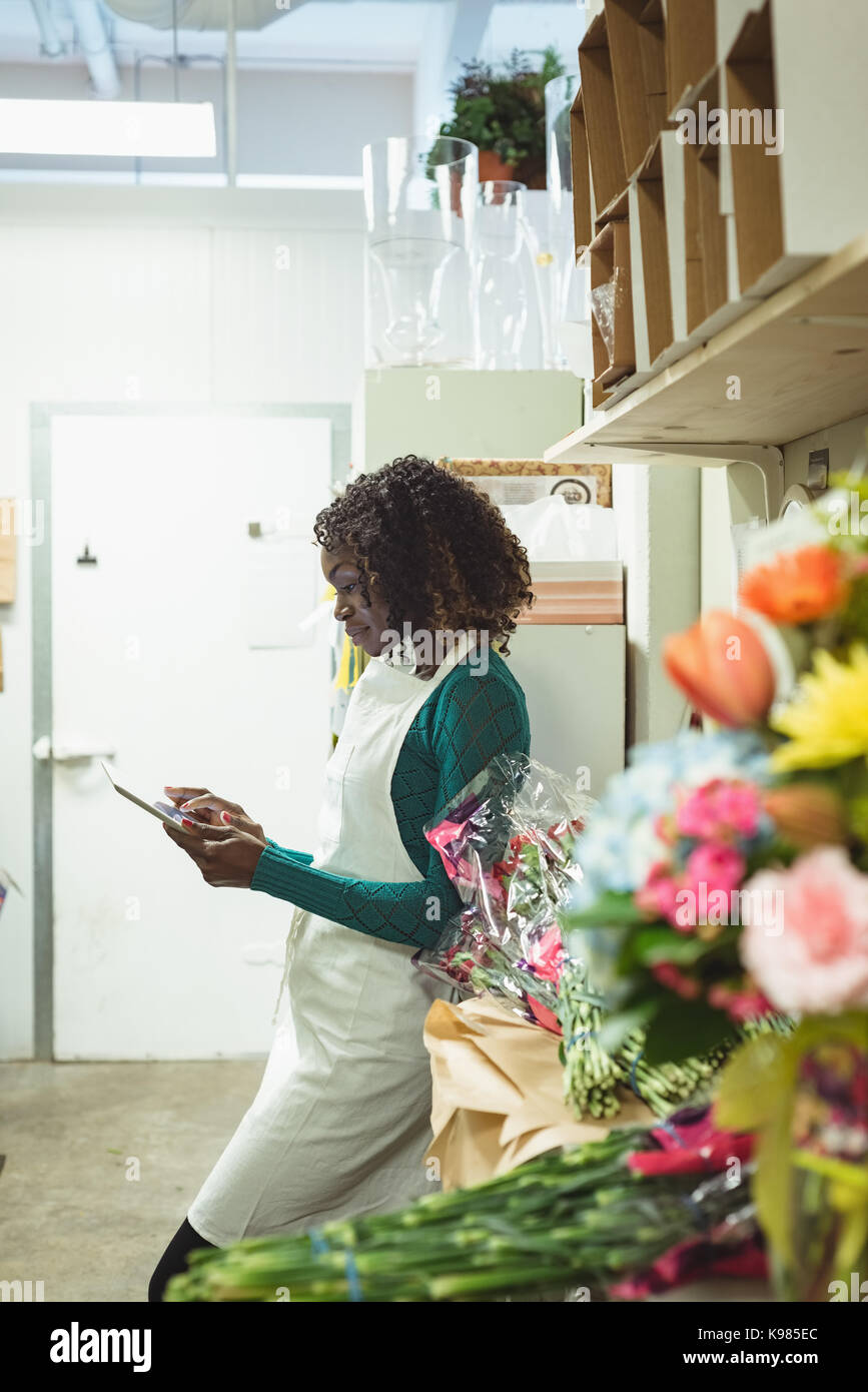 Female florist using digital tablet at his flower shop Stock Photo - Alamy
