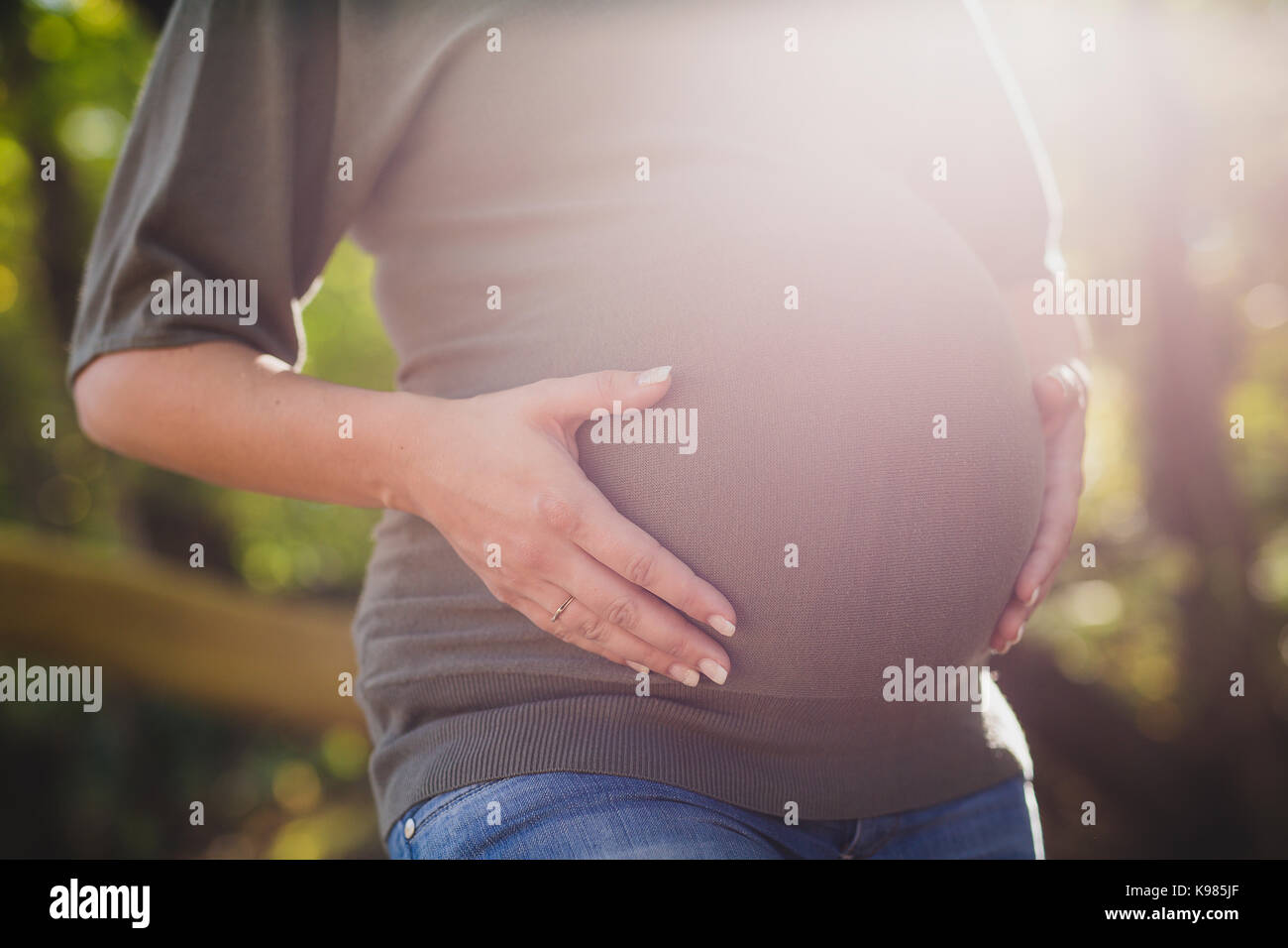 A Closeup pregnant she use hand touch belly Stock Photo - Alamy