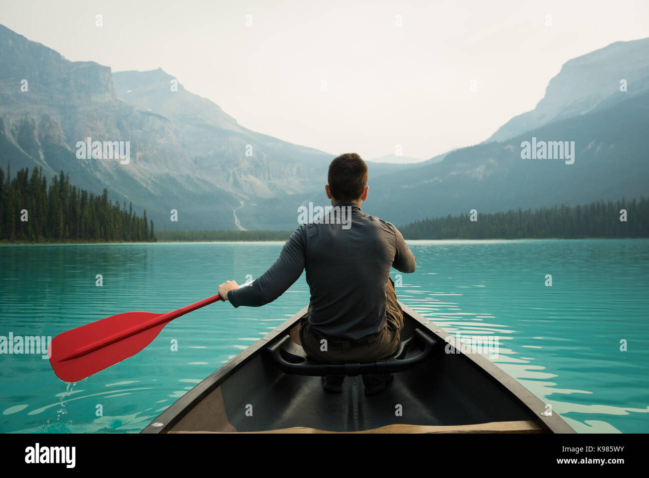 Rear view of man kayaking in lake Stock Photo - Alamy